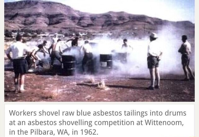 Workers shovel raw blue asbestos tailings into drums at an asbestos ...